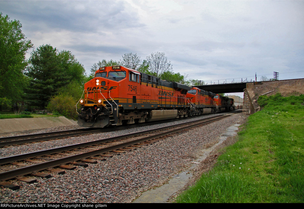 BNSF 7546 Takes a stack train Wb under the Old Bn line.